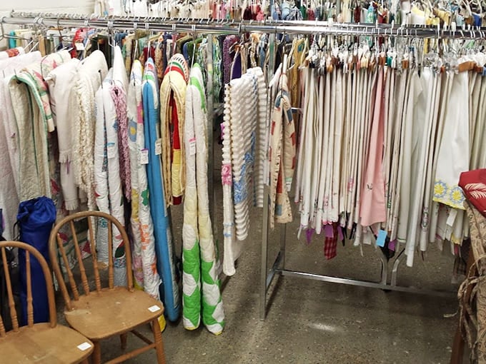 Vintage fabrics and linens hang like a textile rainbow, ready for crafters or anyone seeking unique home accents.