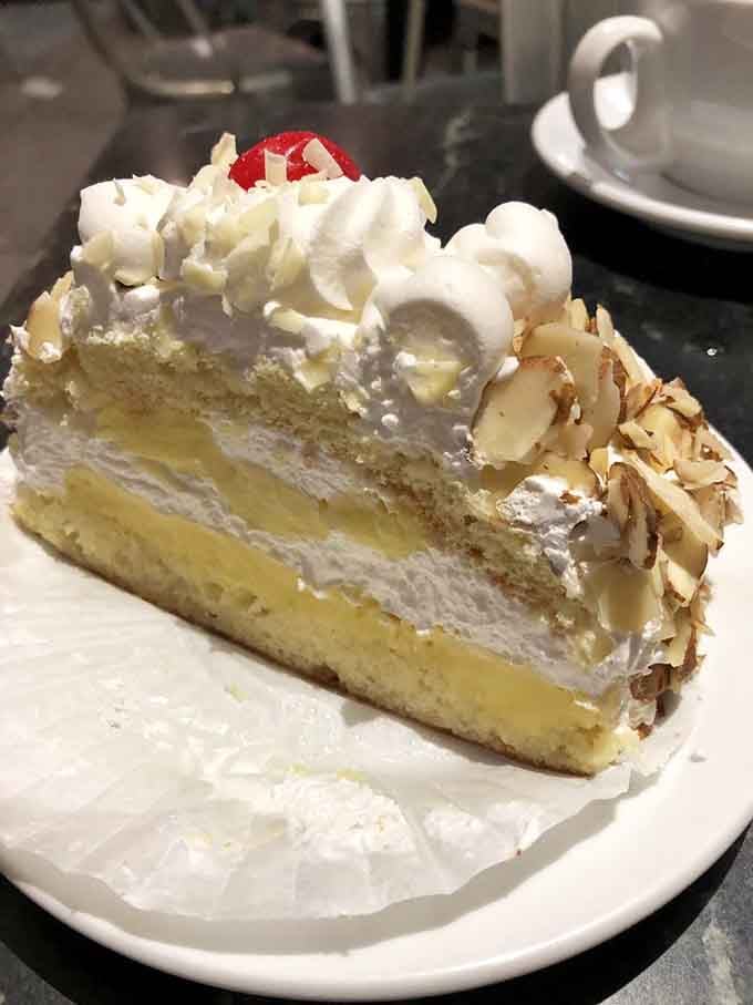 Layers of rum-soaked cake topped with whipped cream and toasted almonds, basically a vacation in pastry form.