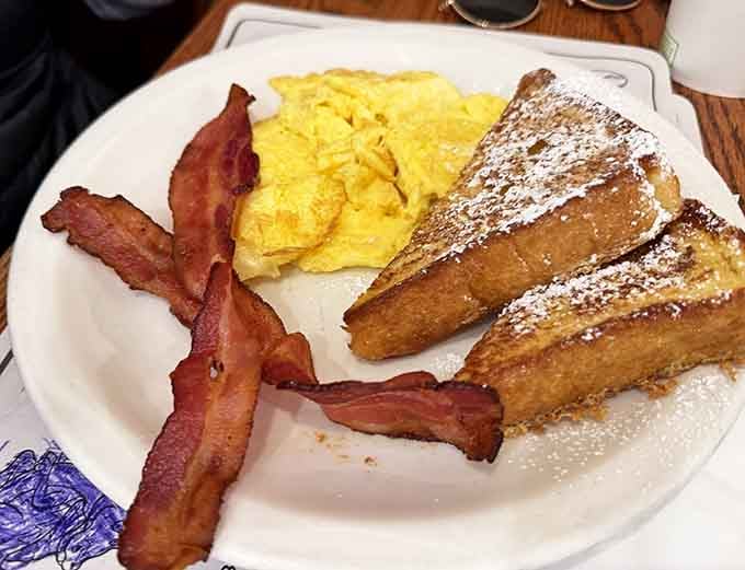 French toast dusted with powdered sugar, bacon standing at attention: perfection doesn't need fancy plating.