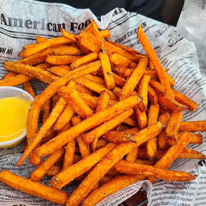Sweet potato fries piled high like edible treasure, golden and crispy enough to convert the skeptics.