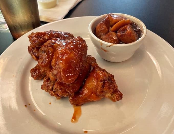 Crispy BBQ wings with candied yams on the side, because why choose between savory and sweet?