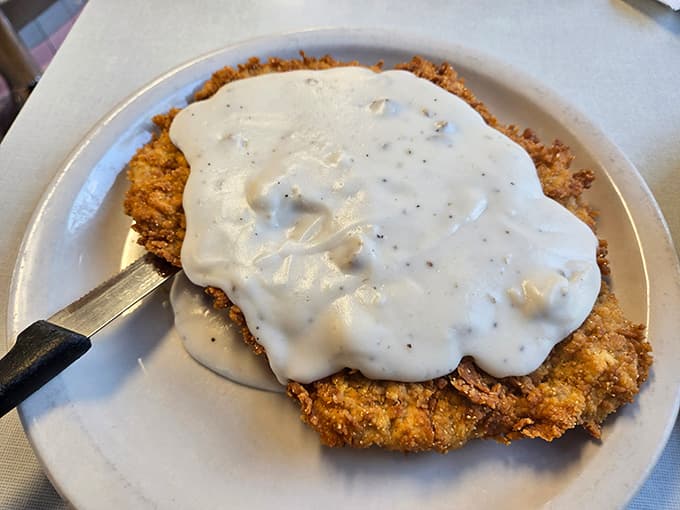 Country fried steak smothered in peppery gravy, proving that some comfort foods never go out of style for good reason.