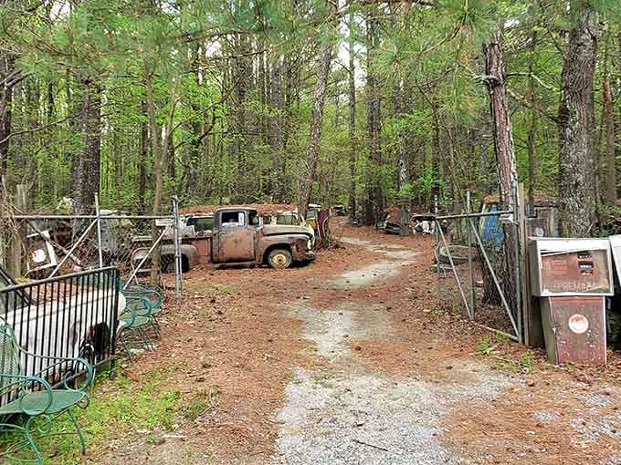 The entrance pathway promises adventure, flanked by vintage gas pumps and automotive relics from another era.