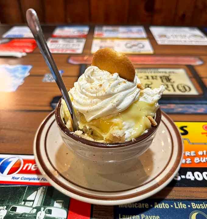 Banana pudding crowned with whipped cream and a vanilla wafer, because you earned it.