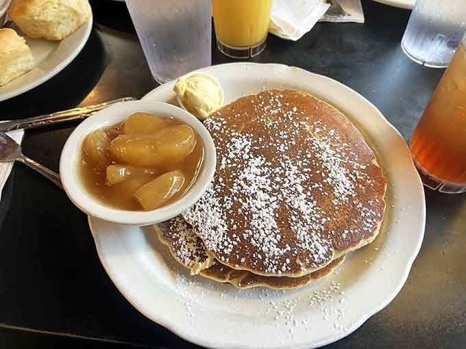 Pancakes dusted with powdered sugar and served with warm apples prove that breakfast dessert is absolutely a thing.