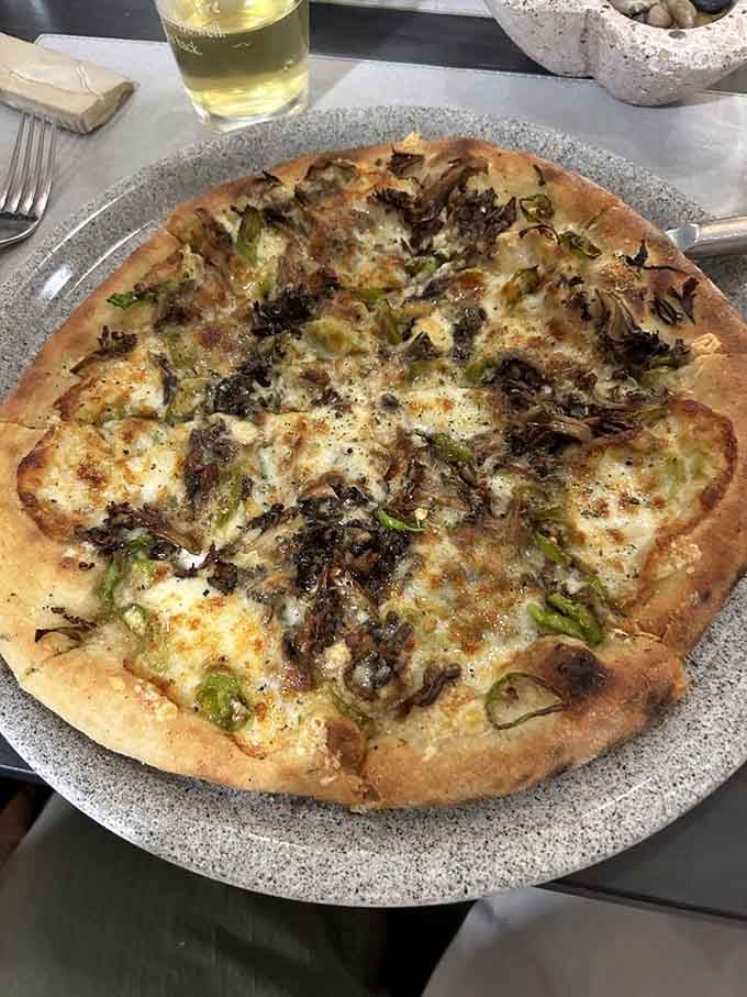 The Mortadella pizza brings Italian sophistication to your table with creamy cheese and delicate, flavorful cured meat slices.