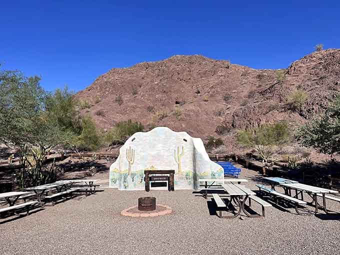 Desert picnic perfection. This artistic gathering space with its painted backdrop provides welcome shade and a touch of Southwestern charm.