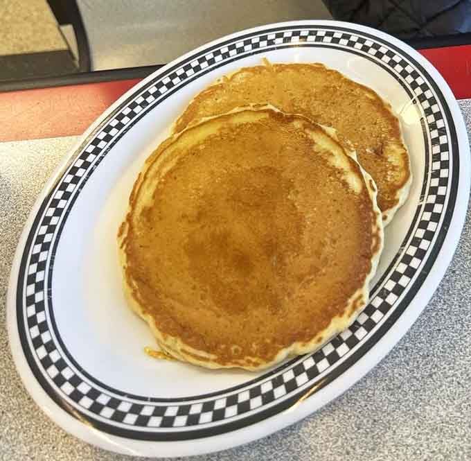 Pancakes so perfectly golden they belong in Fort Knox, ready to soak up rivers of syrup and dissolve your morning grumpiness in buttery bliss.