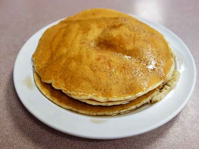 Golden pancakes that achieve that elusive balance: crisp at the edges, fluffy in the middle, and ready for their jam-based destiny.