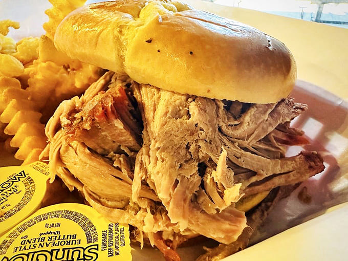 Pulled pork piled this high on a soft bun isn't just lunch; it's an architectural achievement.