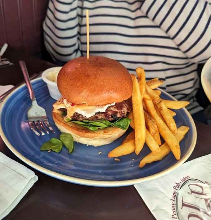 A perfectly stacked burger with a golden bun and crispy fries delivers exactly what you're craving without apology.