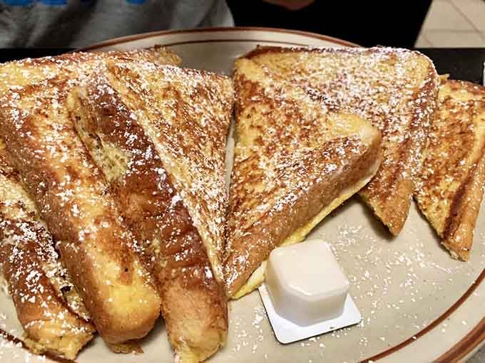 French toast dusted with powdered sugar, golden and thick like breakfast should always be.