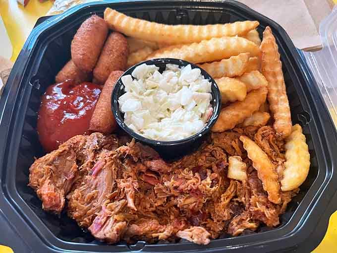 This platter showcases the full Pierce's experience: tender pulled pork, crispy fries, golden hushpuppies, and creamy coleslaw in perfect harmony.