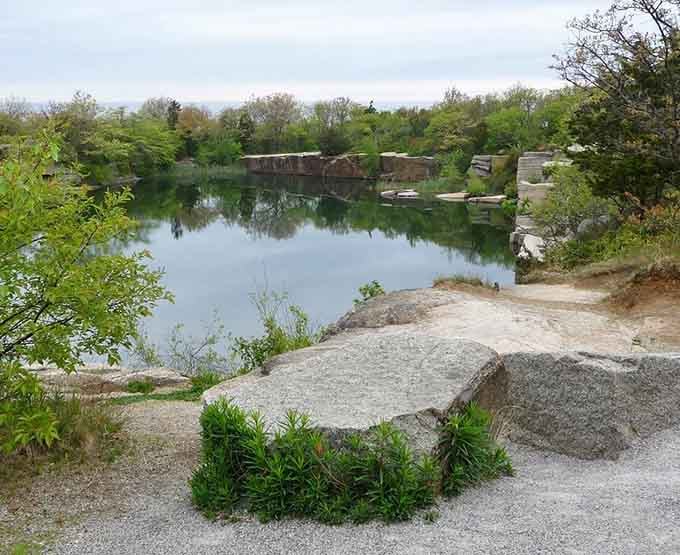 The quarry's glassy surface perfectly mirrors the sky above. It's like Massachusetts decided to create its own slice of Scandinavian scenery.