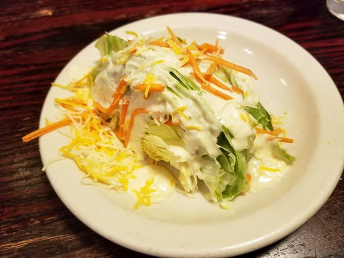 A proper wedge salad with creamy dressing and shredded cheese, because even steak lovers need their vegetables sometimes.