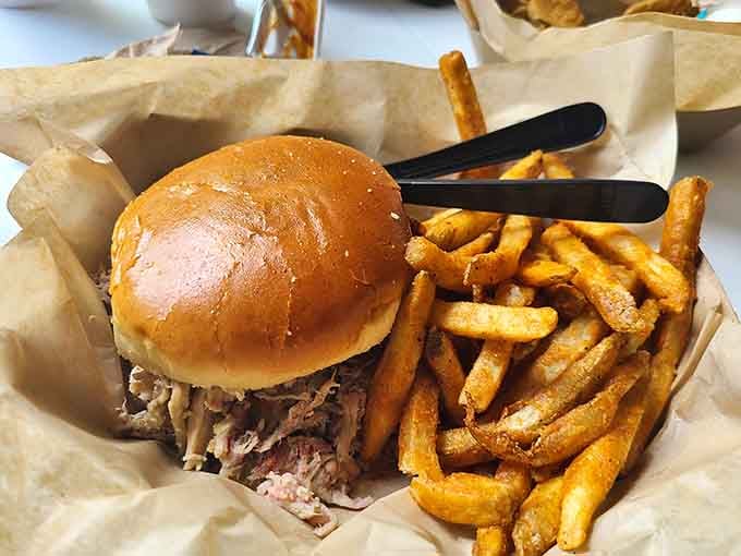Pulled pork piled so high, the sandwich bun is doing some serious structural engineering work.