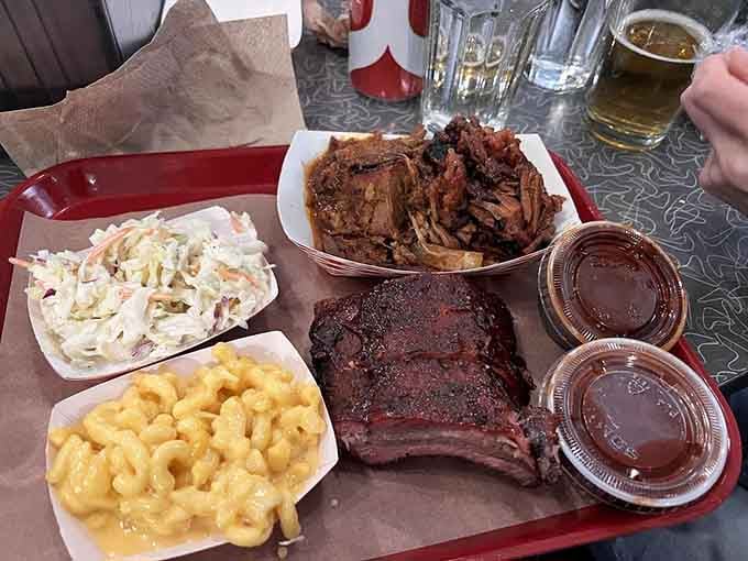 Behold the holy trinity: tender ribs, smoky brisket, creamy mac and cheese, and tangy slaw perfection.