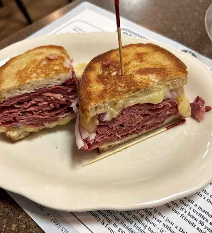 Behold the Reuben in all its grilled glory, where corned beef meets Swiss cheese in perfect harmony.
