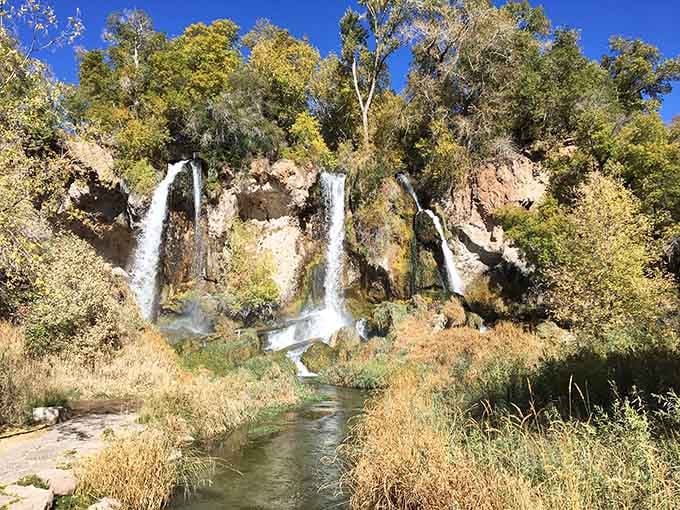 Triple waterfalls cascading down limestone cliffs, because apparently one waterfall just wasn't showing off enough.