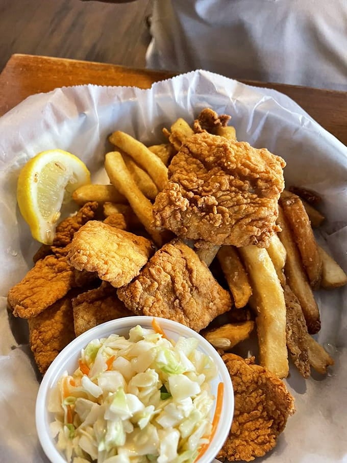 Golden fried fish with fries and slaw, comfort food that tastes like summer vacation feels, perfectly executed.