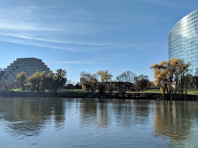 Modern buildings meet natural beauty where the city skyline reflects off the water like a California postcard come alive.
