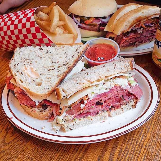 A table full of sandwiches that could feed a small army or one very determined lunch crowd.