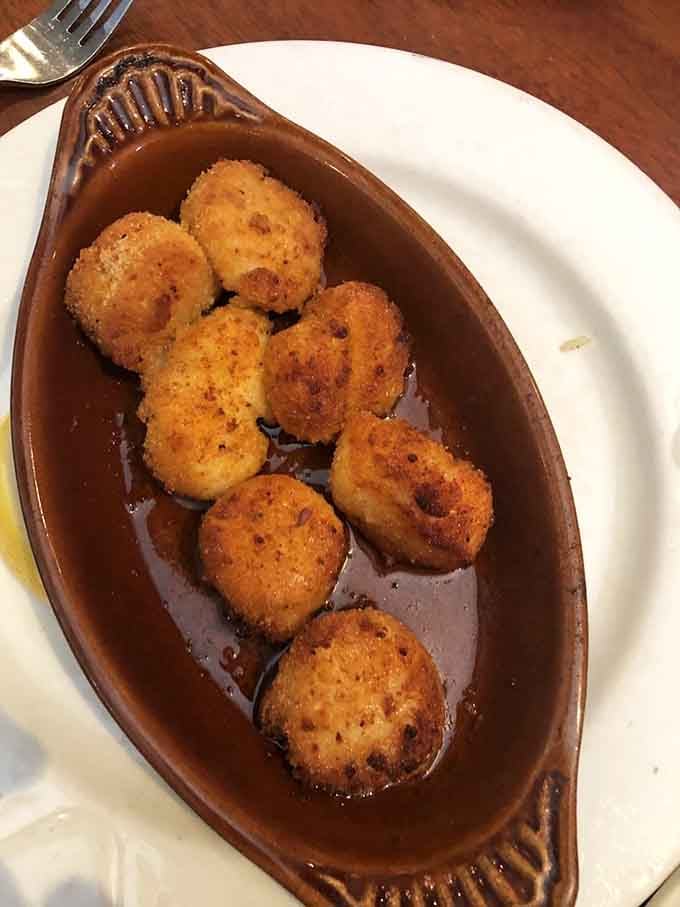 Golden-brown scallops swimming in savory sauce. These little ocean treasures have been transformed into something that would make Neptune himself jealous.