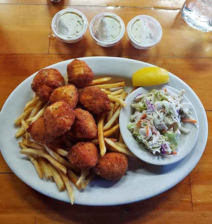 Golden-fried scallops with crispy fries and homemade slaw &ndash; the holy trinity of New England comfort food done right.