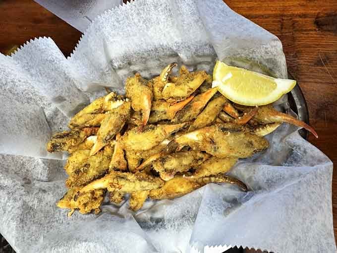 Golden fried crab claws piled high like edible treasure, because sometimes the best things in life require getting your hands dirty.