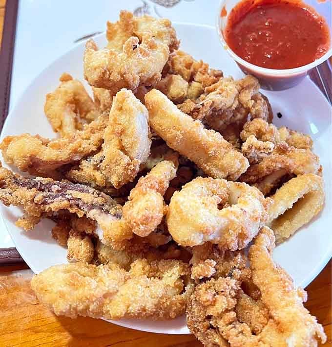 Golden calamari rings that prove the ocean's rubber bands can be absolutely delicious when done right.
