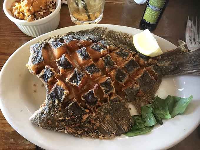 That's a whole flounder showing off its grill marks like a badge of honor, and yes, it tastes even better than it looks.