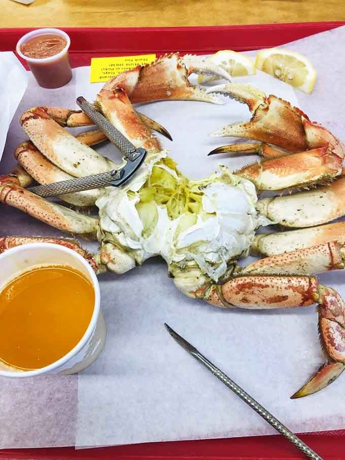 Fresh Dungeness crab sprawled across a tray like ocean royalty, complete with melted butter and crackers for the coronation ceremony.