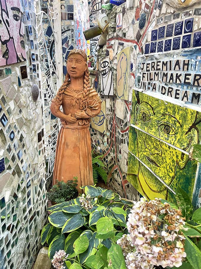 Folk art meets fine art. This terracotta figure stands sentinel among the mosaics, a calm presence amid the visual symphony.