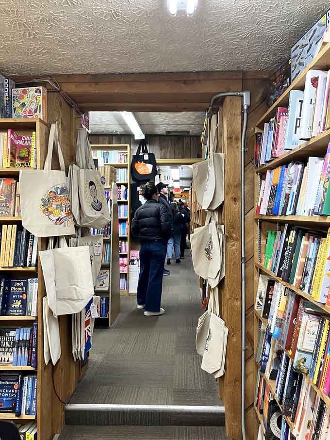 Canvas totes hanging overhead like they know you'll need reinforcements for carrying out your literary haul today.