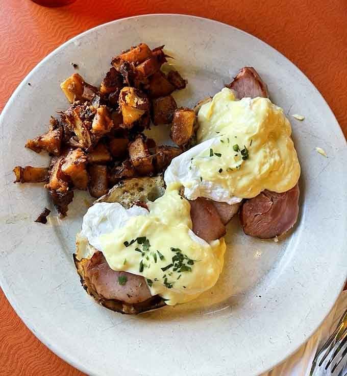 Eggs Benedict done right, with hollandaise that pools like liquid gold and home fries that earned their spot on the plate.