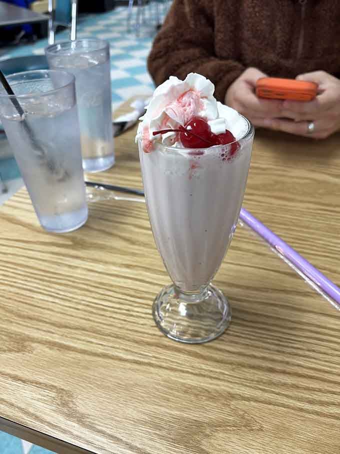 A strawberry milkshake topped with whipped cream and a cherry, because some classics never need updating or apologies.