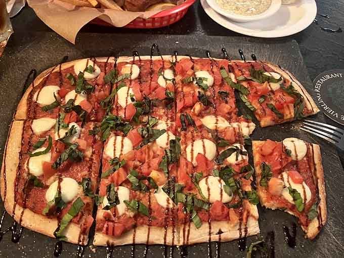 Fresh mozzarella, ripe tomatoes, and basil on crispy flatbread create an Italian masterpiece that would make your nonna smile with approval.