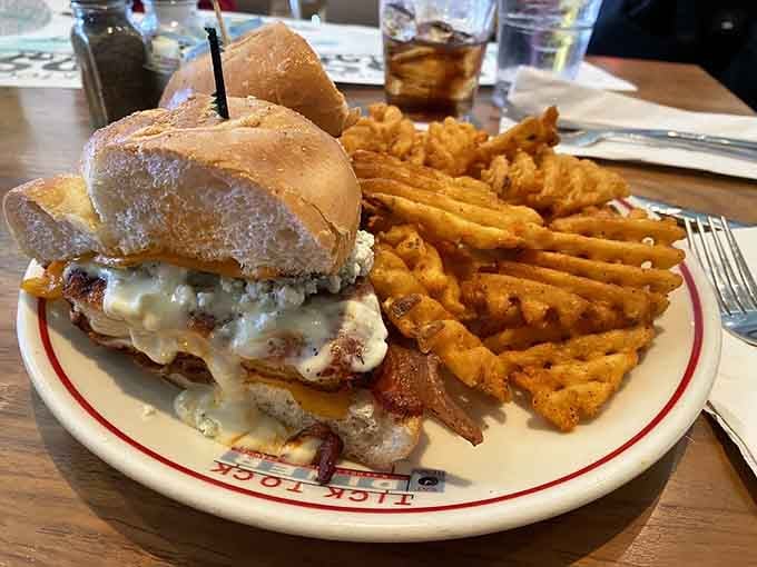 Buffalo chicken meets melted cheese on a bun that barely contains the glorious chaos within those waffle fries.