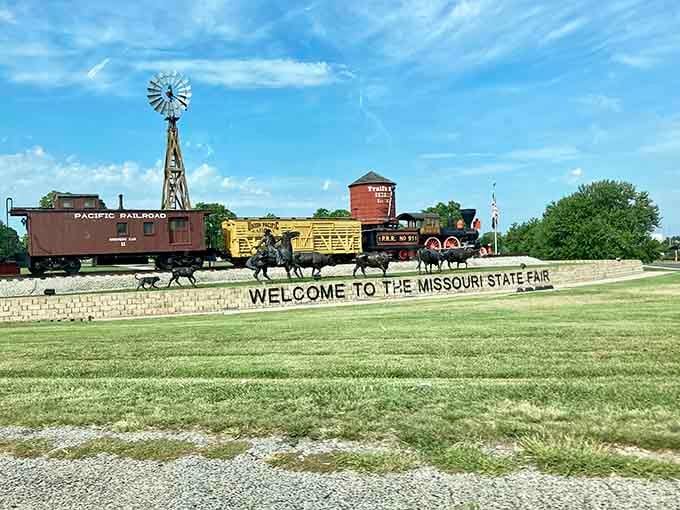 The Missouri State Fair entrance welcomes visitors with vintage train cars and a windmill, nodding to the state's agricultural heritage.