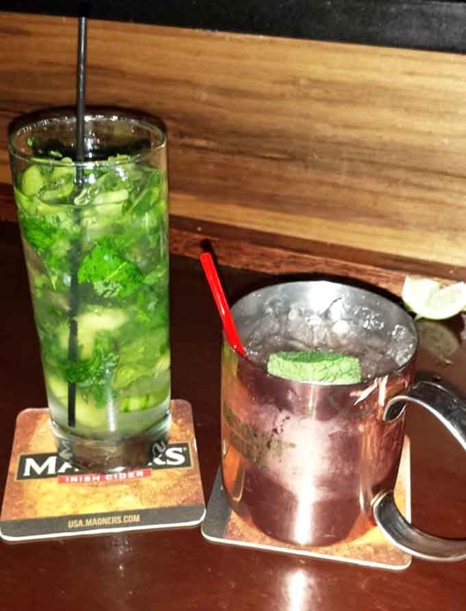 A frosty mojito and copper mug Moscow Mule sitting pretty, ready to make your vault experience even better.