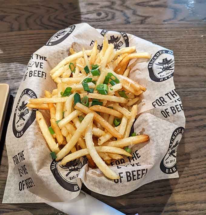 These aren't just fries; they're golden wands of potato magic, dusted with herbs and ready to disappear faster than you can say "just one more."