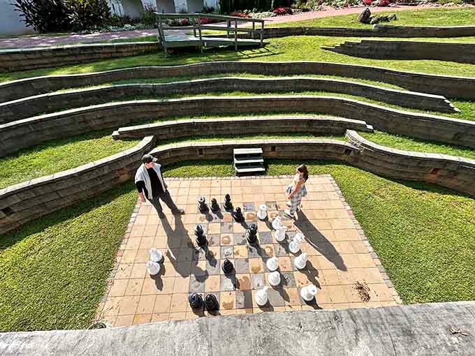 Giant chess pieces on tiered amphitheater seating turn strategic thinking into full-body workout entertainment for all ages.