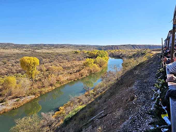 The Verde River snakes alongside golden cottonwoods, creating a ribbon of life through the high desert landscape.