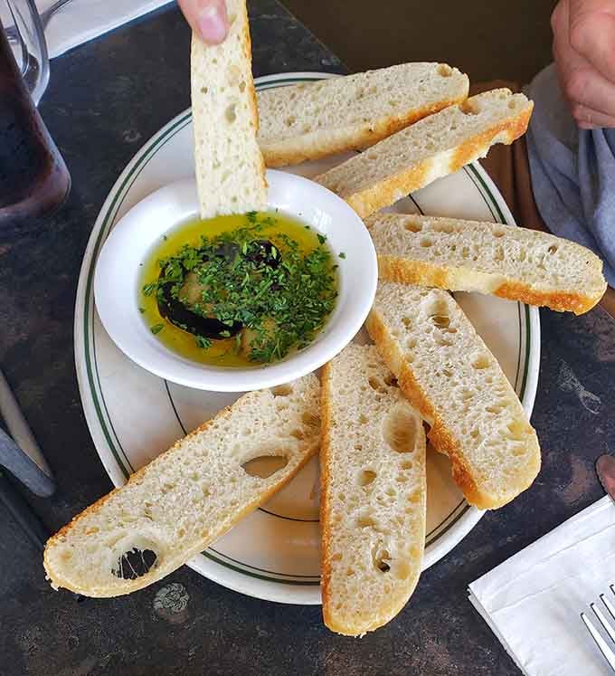Warm bread meets herb-infused olive oil in this simple starter that somehow tastes like a Mediterranean vacation.