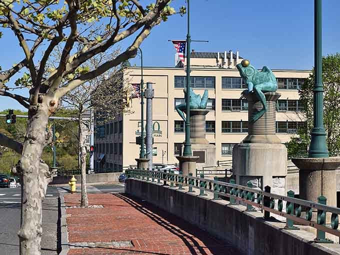 Four massive frogs commemorate a colonial panic attack over mating amphibians, because history should always be this entertaining and bizarre.