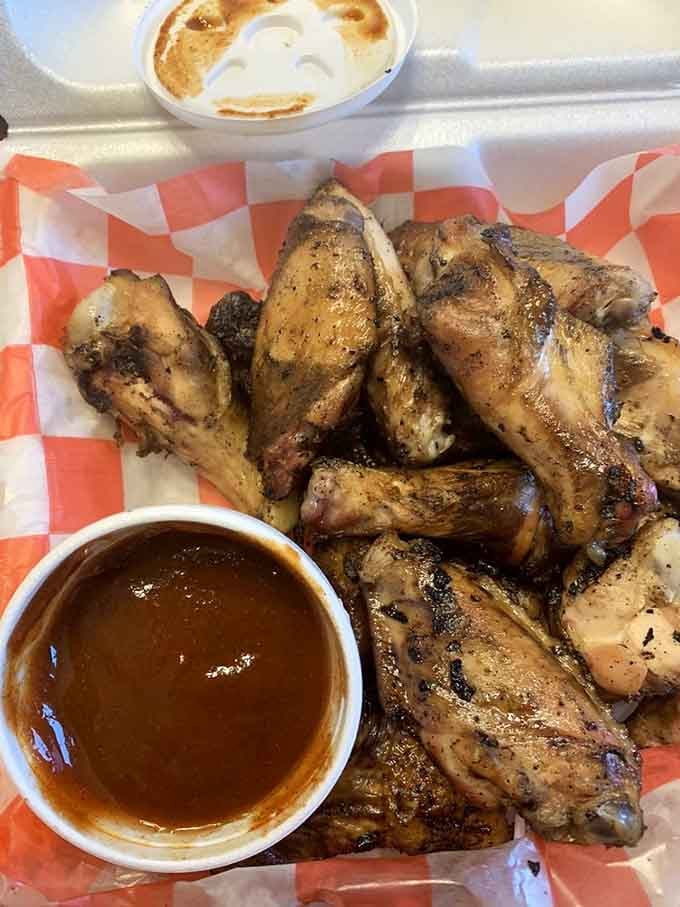 These wings aren't trying to fly—they're trying to make you forget every other wing you've ever had. The sauce cup is just their wingman.