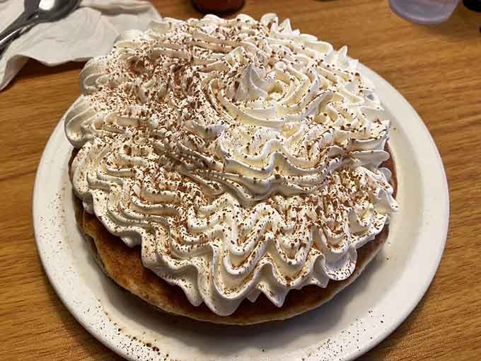 Whipped cream piled higher than Mount Rushmore on tiramisu pancakes is the kind of excess we can all support.