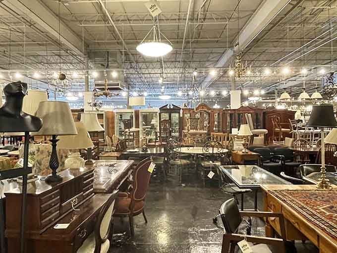 Chandeliers casting pools of warm light over an ocean of fine furniture. It's like a ballroom where tables and chairs have gathered to dance after the humans have gone home.