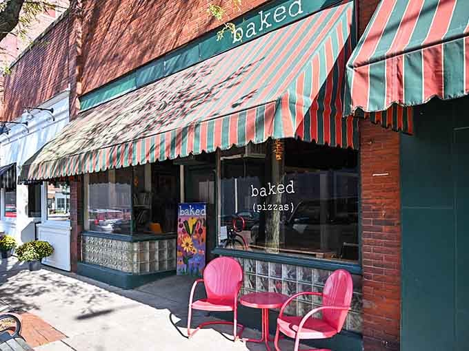 Baked Pizza's striped awning signals what every neighborhood needs&mdash;a spot where artisanal crusts meet creative toppings, and pink chairs invite lingering conversations.