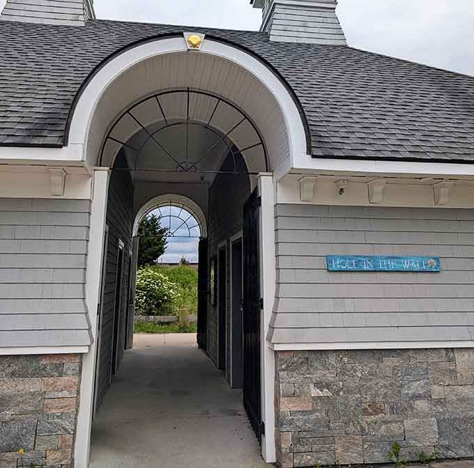 Not just a pretty archway—this charming structure welcomes beach-goers with a sign that perfectly captures its whimsical name.